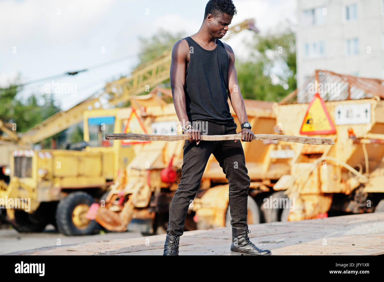 Portrait of an african american man using tools and equipment on the ...