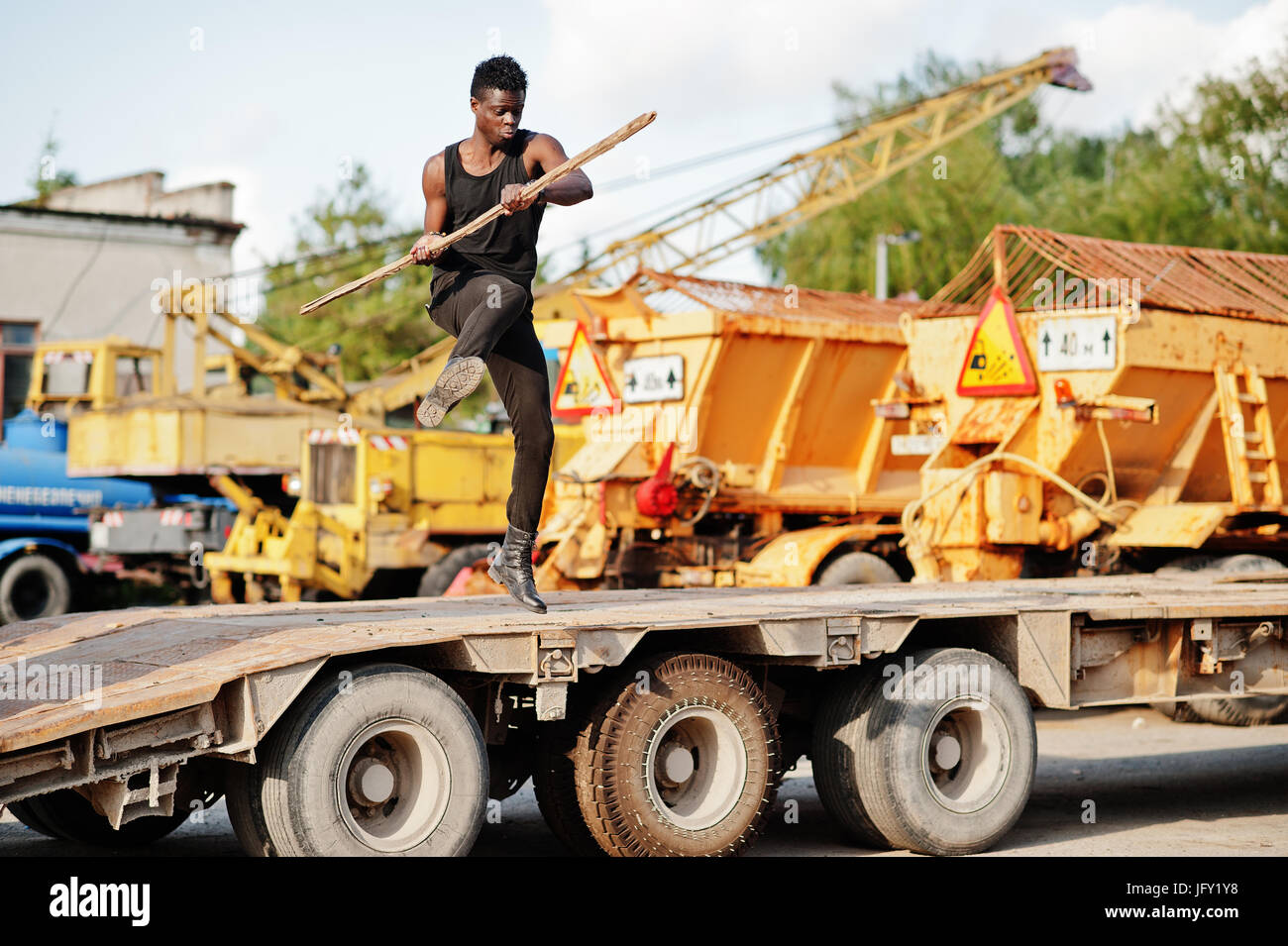Portrait of an african american man using tools and equipment on the ...