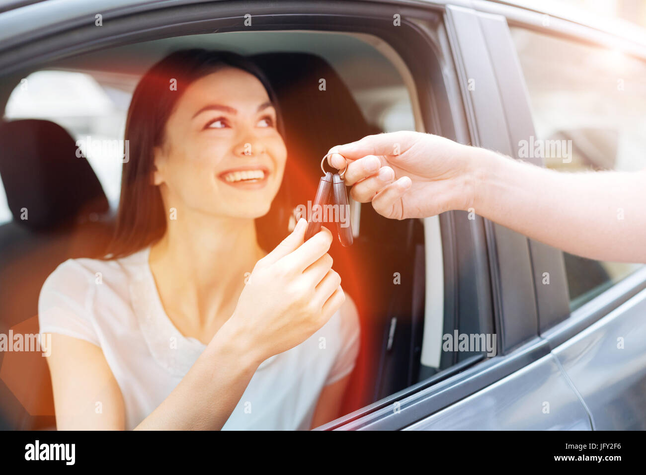Happy charming woman receiving car keys Stock Photo - Alamy