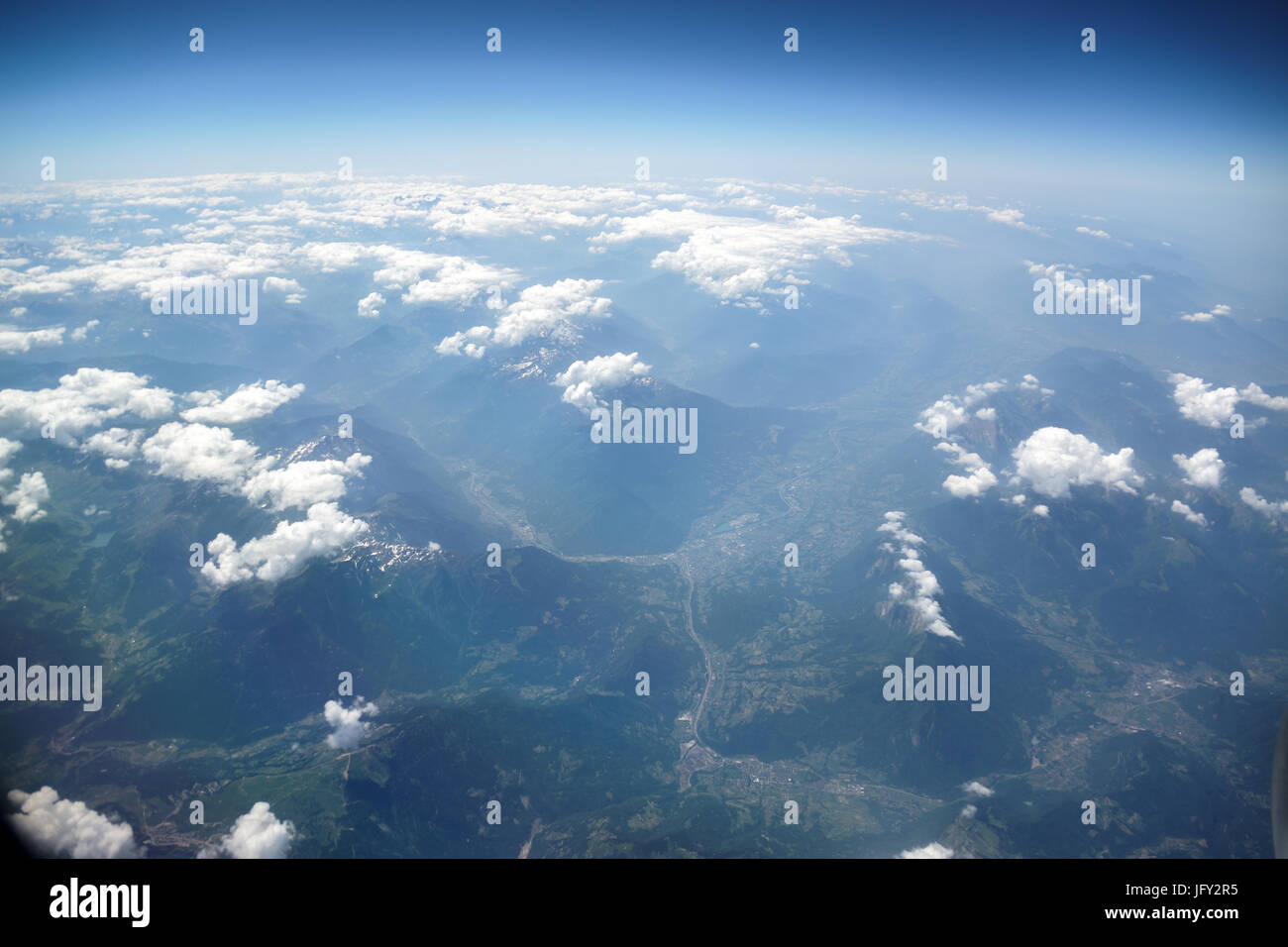 A photograph taken at an extremely high altitude of the Alps, rivers ...