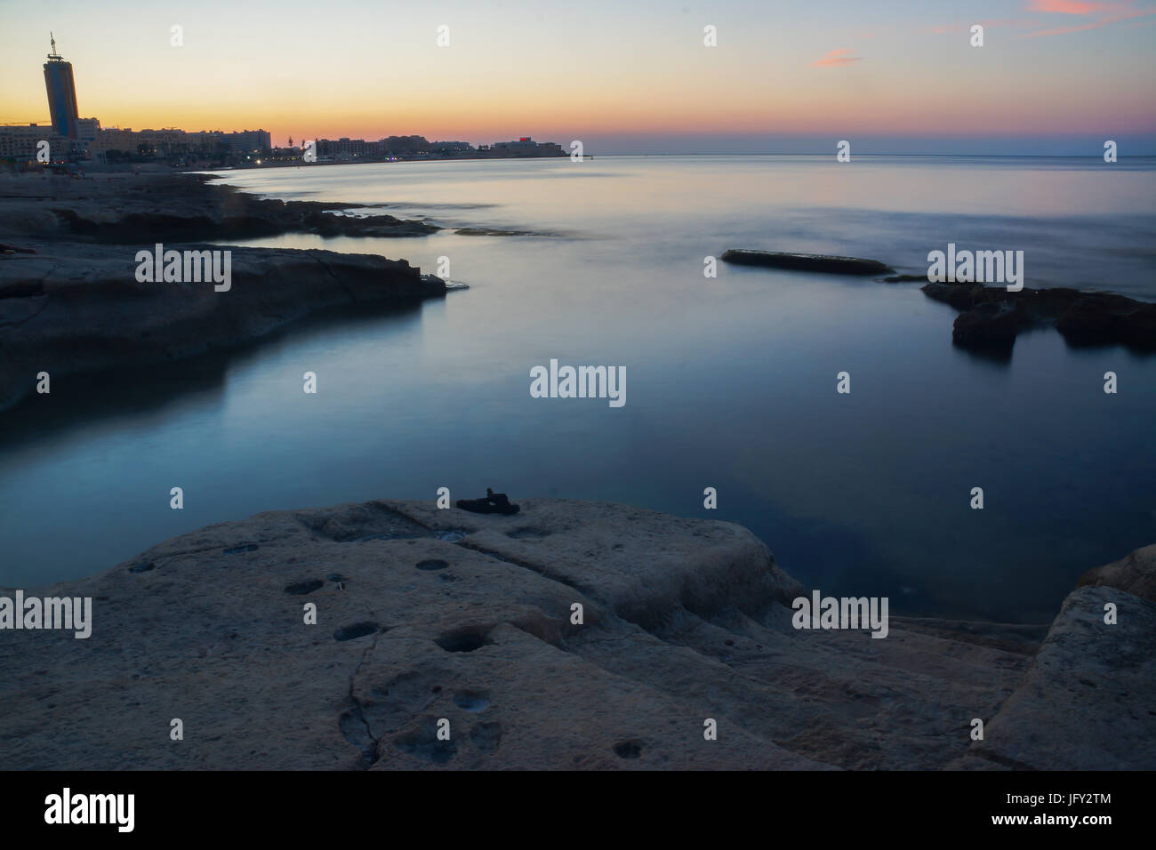 A long exposure photograph of the waterfront in Silema, Malta. Stone ...