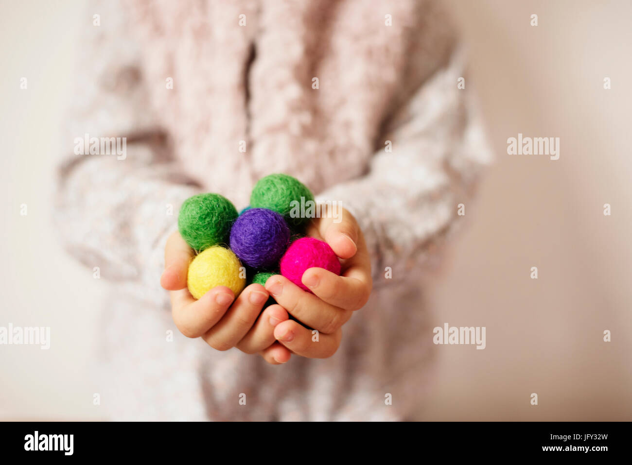 Close up of children hands holding colorful felt balls. Child, kid ...