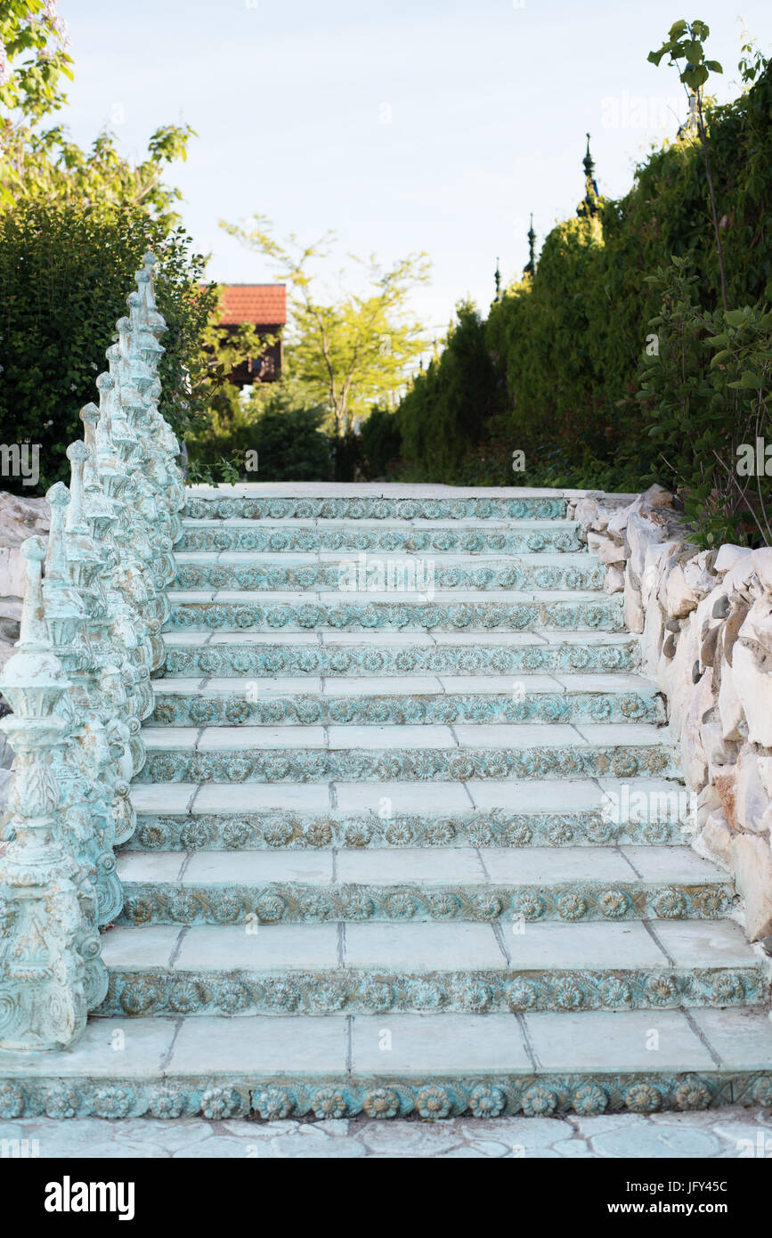 Old baroque stairs, outdoors. Stairs made of stone. Alley in beautiful ...