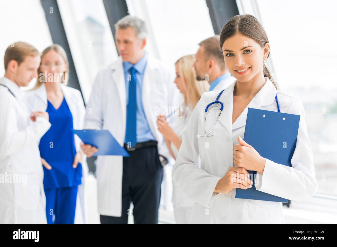 Young female doctor and medical team in hospital Stock Photo - Alamy