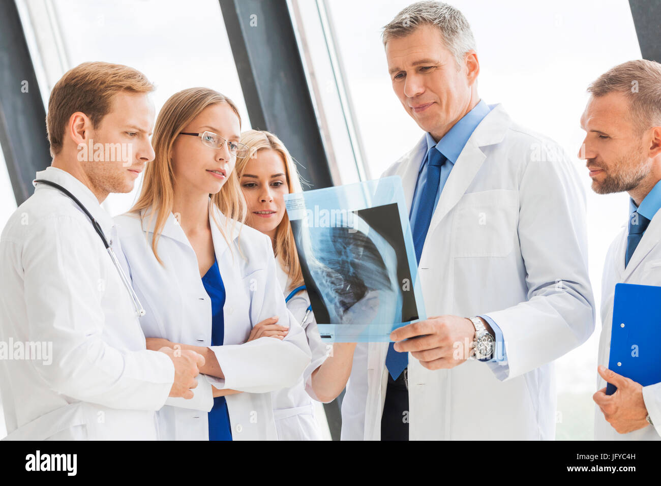 Group of doctors look and discuss x-ray in a clinic or hospital Stock ...