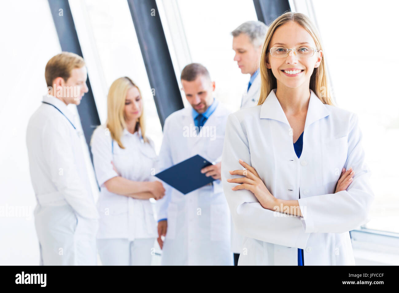 Young female doctor and medical team in hospital Stock Photo - Alamy