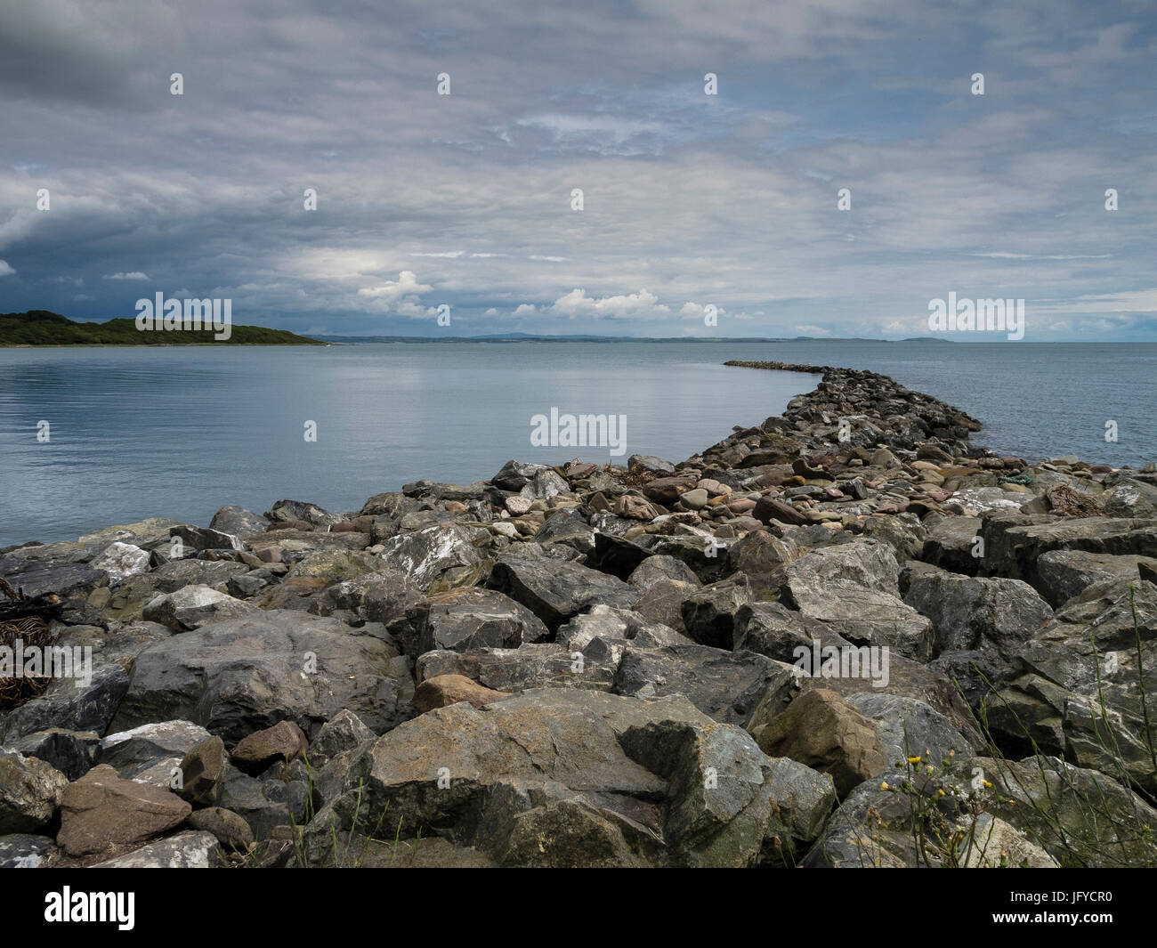 Man-made rock breakwater at the entrance to Garlieston harbour Stock ...