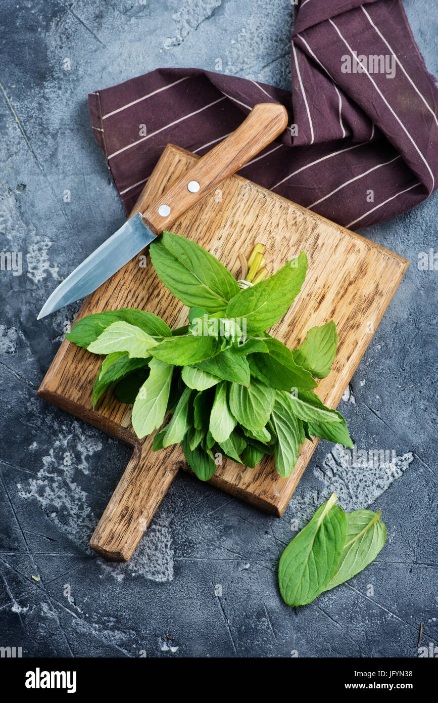 fresh mint on board and on a table Stock Photo - Alamy