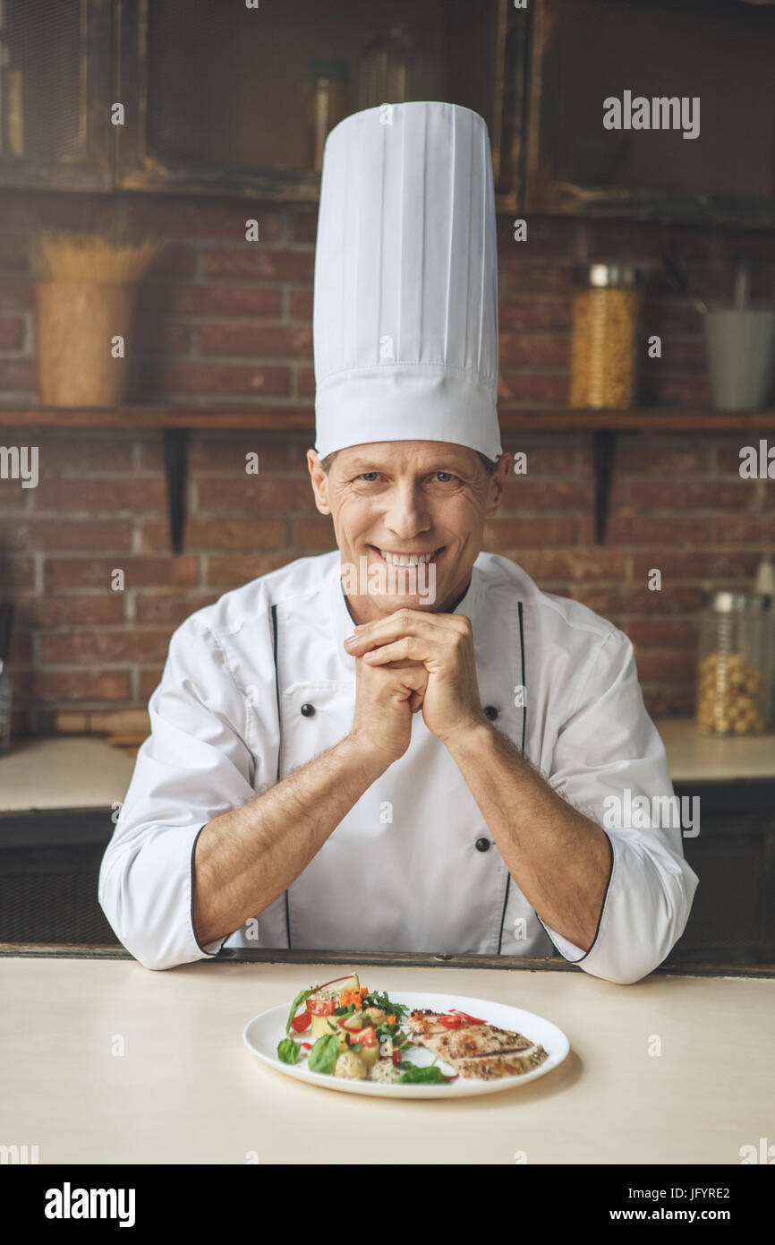 Mature male professional chef cooking meal indoors finished Stock Photo ...