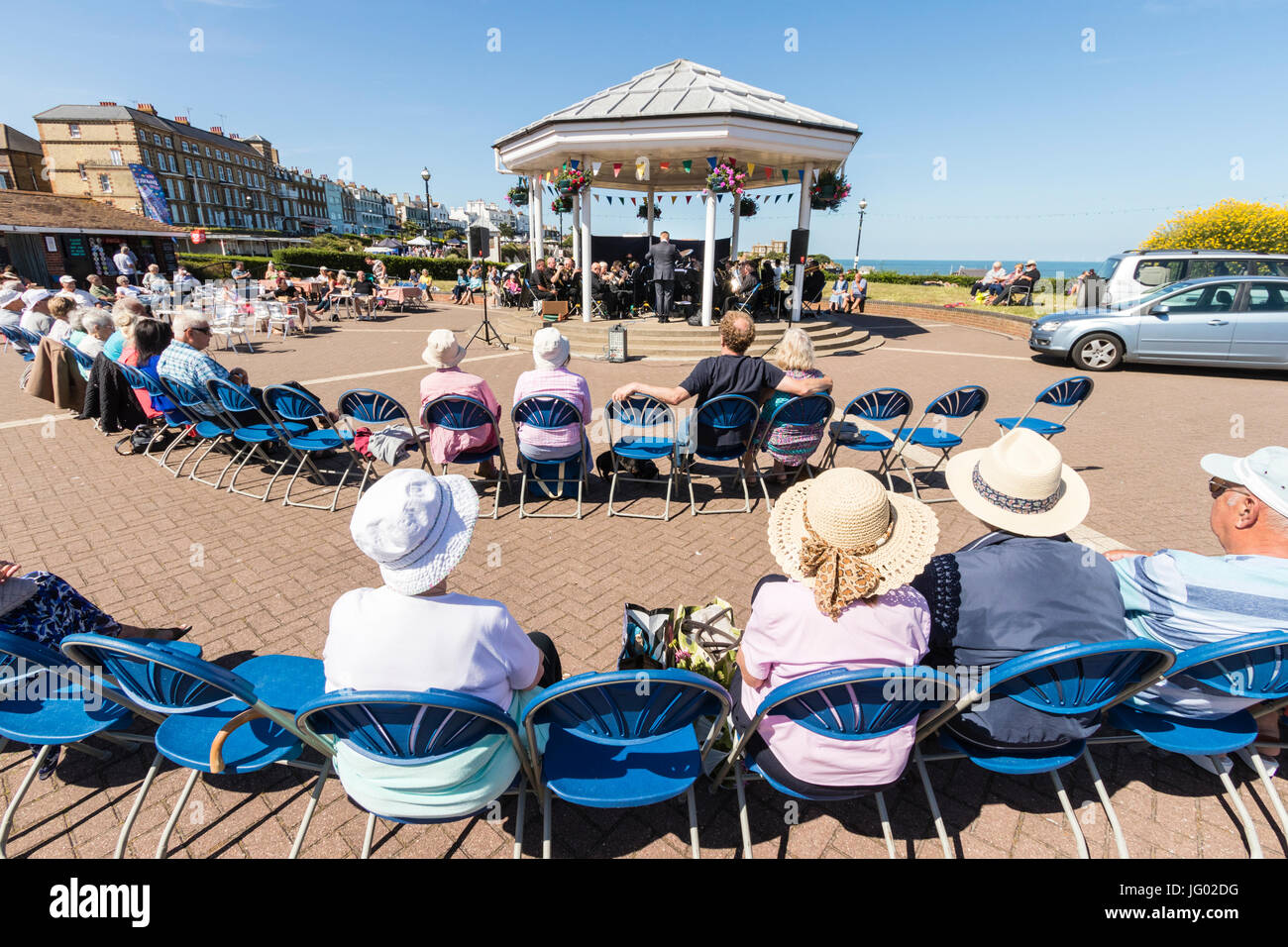 People sitting around bandstand on Broadstairs seafront, watching the ...