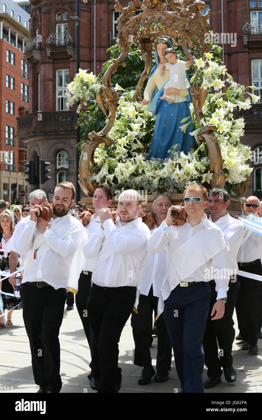 Manchester, UK. 2nd July, 2017. . Men carrying the Madonna statue in ...