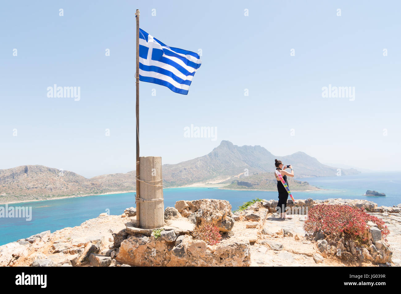 Greek flag flying on a hill at Gramvoussa Castle overlooking Balos ...