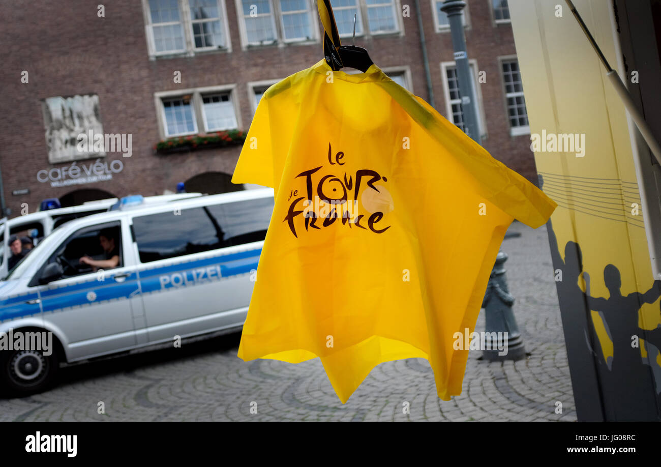A yellow rain cape with the letters "Tour de France" can be seen at a ...