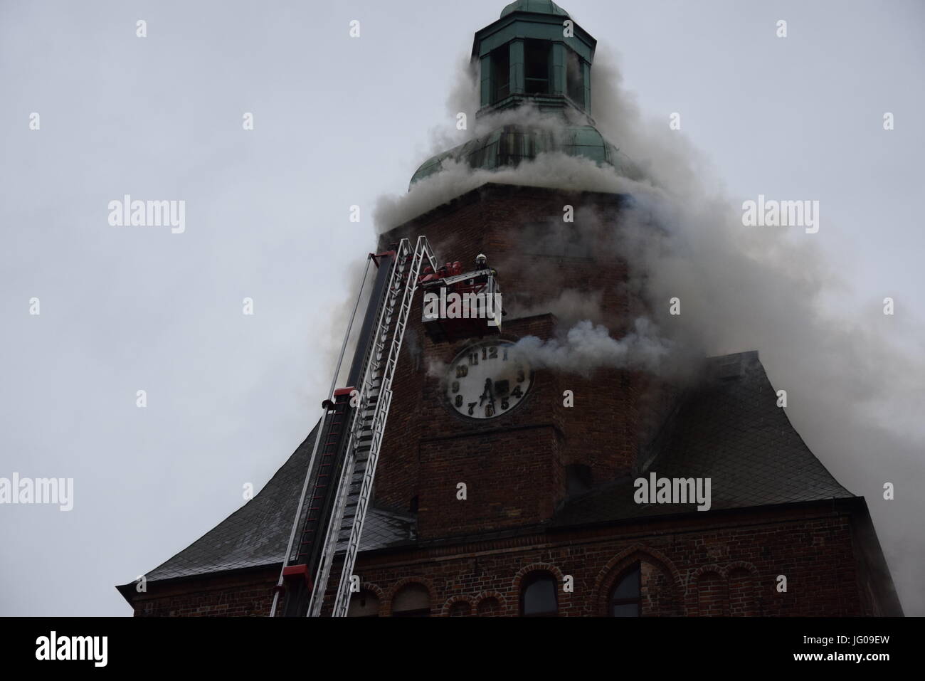 Several dozens of firefighters battle a blaze at the pinnacle of the ...