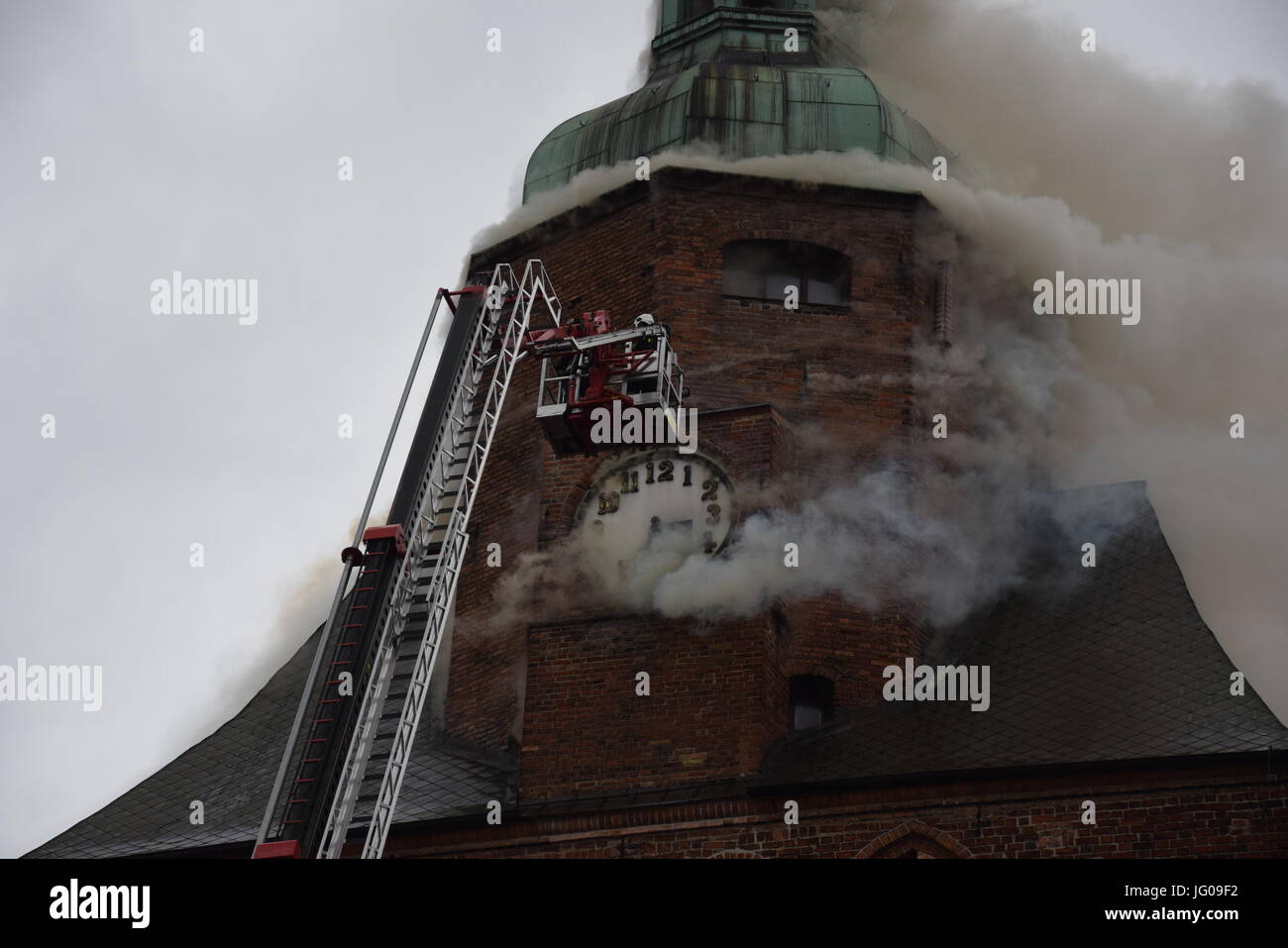 Several dozens of firefighters battle a blaze at the pinnacle of the ...