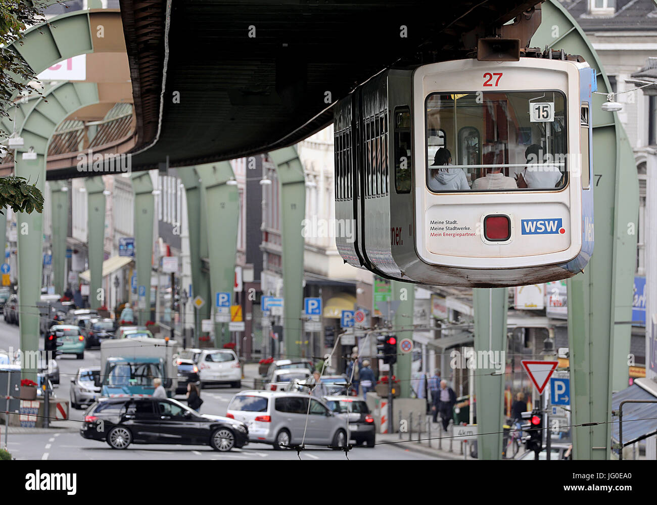 Wuppertal, Germany. 26th June, 2017. A suspension railway train makes its way through the city ...