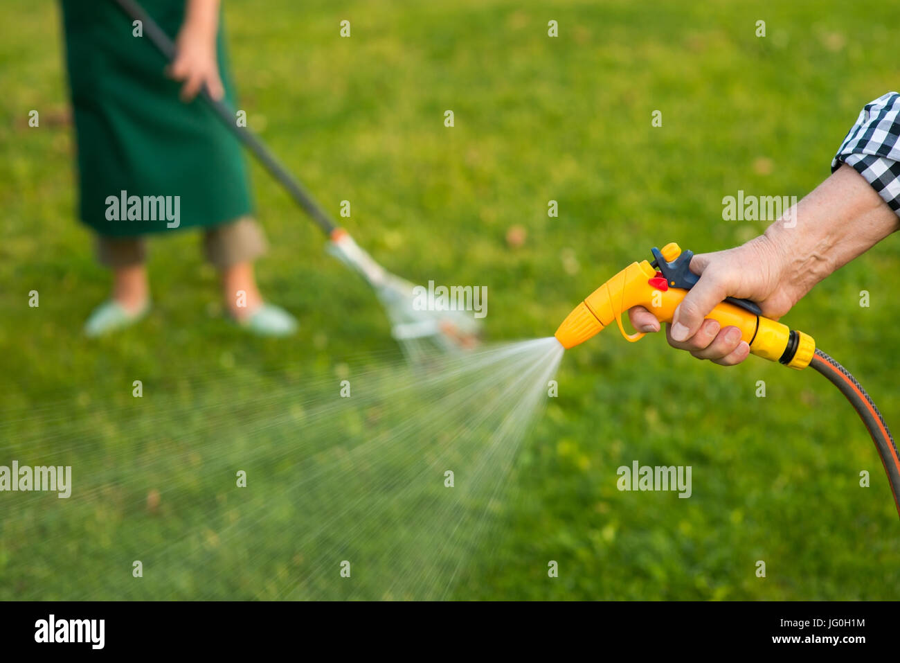 Gardener hand water hose nozzle hi-res stock photography and images - Alamy