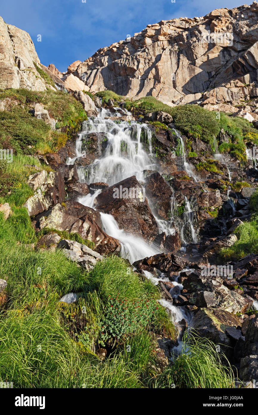 Water cascades down a rocky slope in Rocky Mountain National Park ...