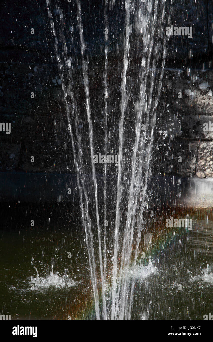 Splashes of water into the air on brick wall background Stock Photo - Alamy