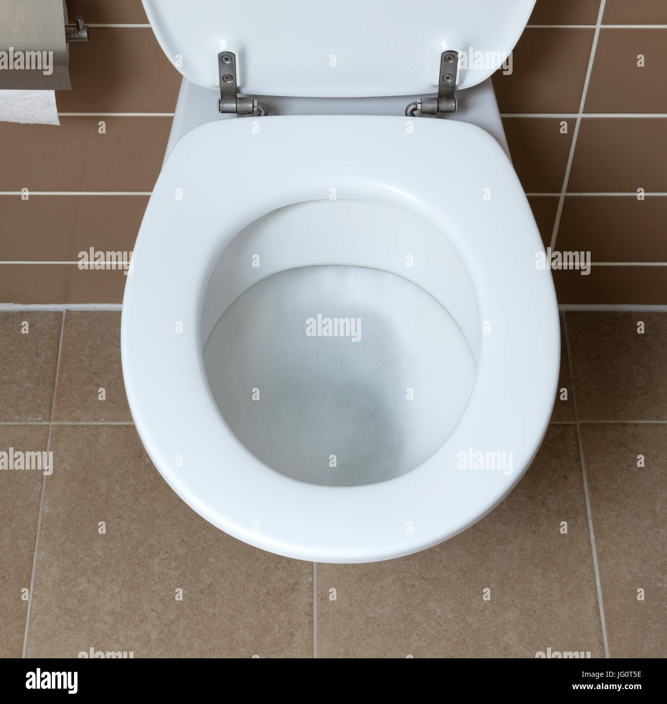 Modern white toilet bowl in the bathroom, flushing Stock Photo - Alamy