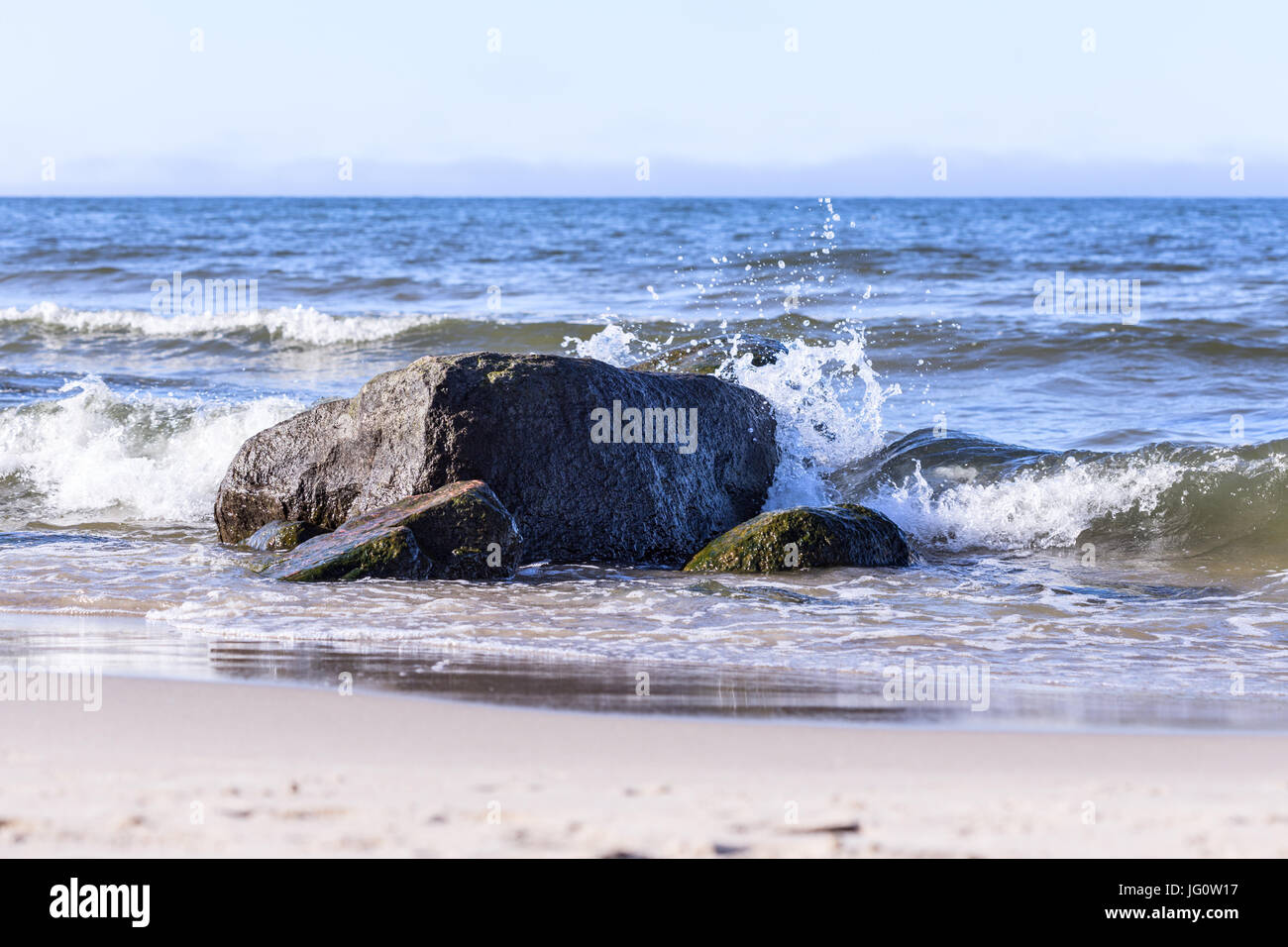 single rock at sea with crashing waves Stock Photo - Alamy
