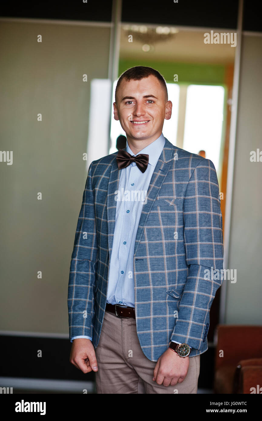 Very handsome groom posing in his room Stock Photo - Alamy