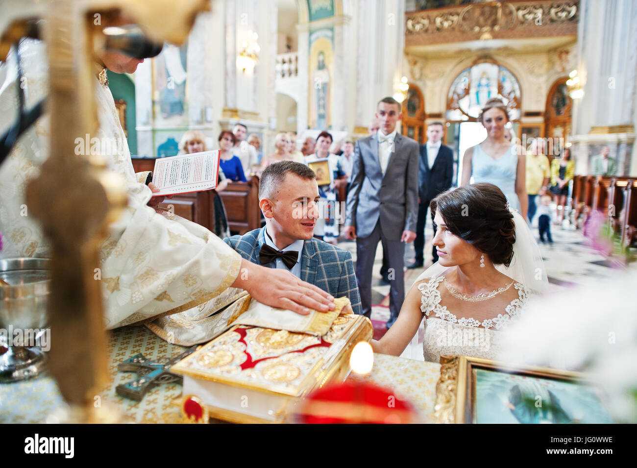 Fantastic bride and handsome groom making vows to each other in the ...