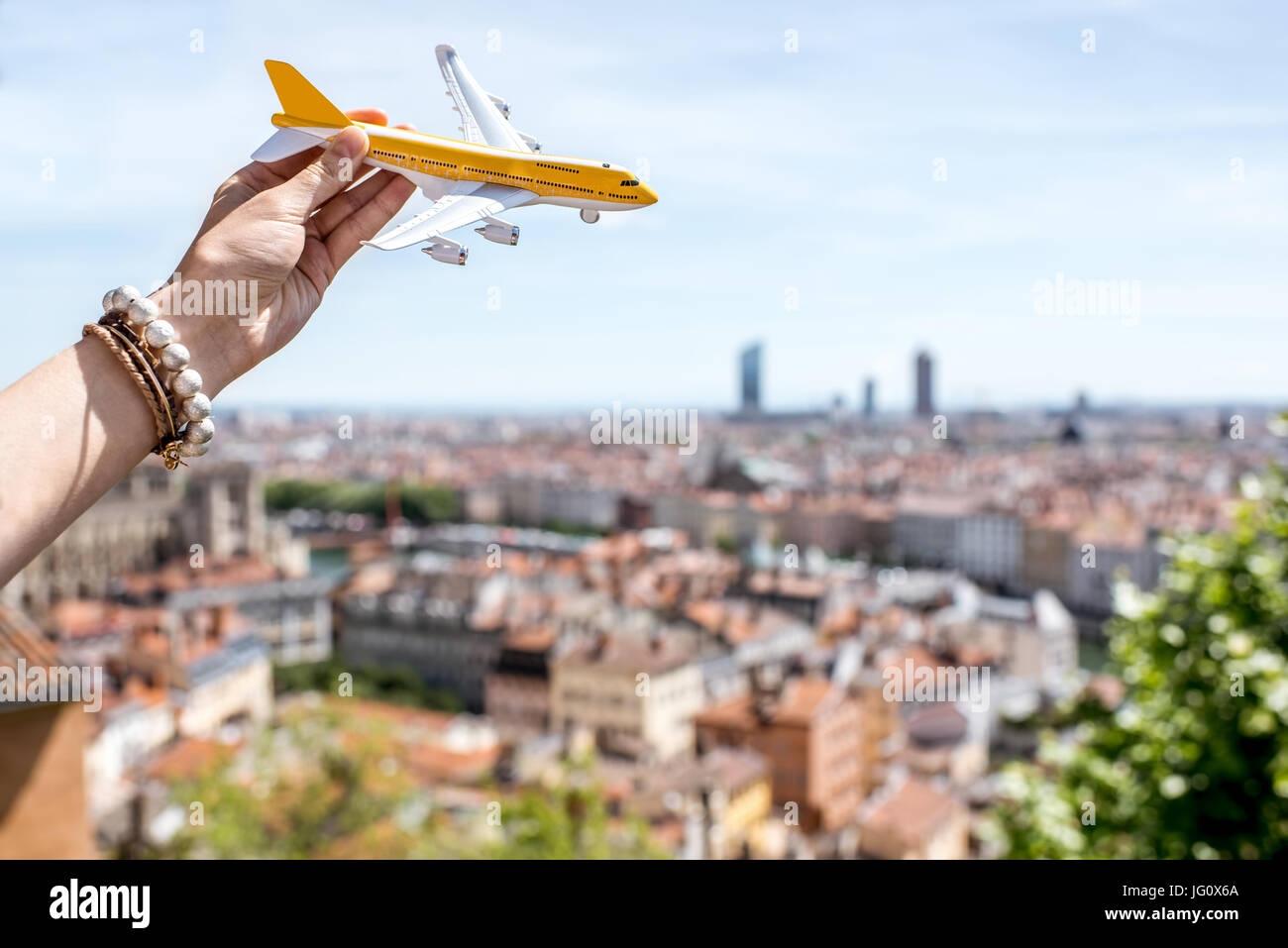 Airplane on the Lyon city background Stock Photo - Alamy