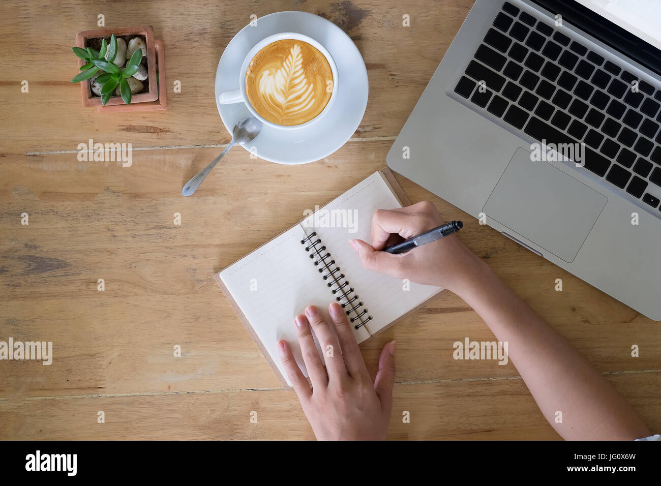 Top view hand writing on notebook on office table Stock Photo - Alamy