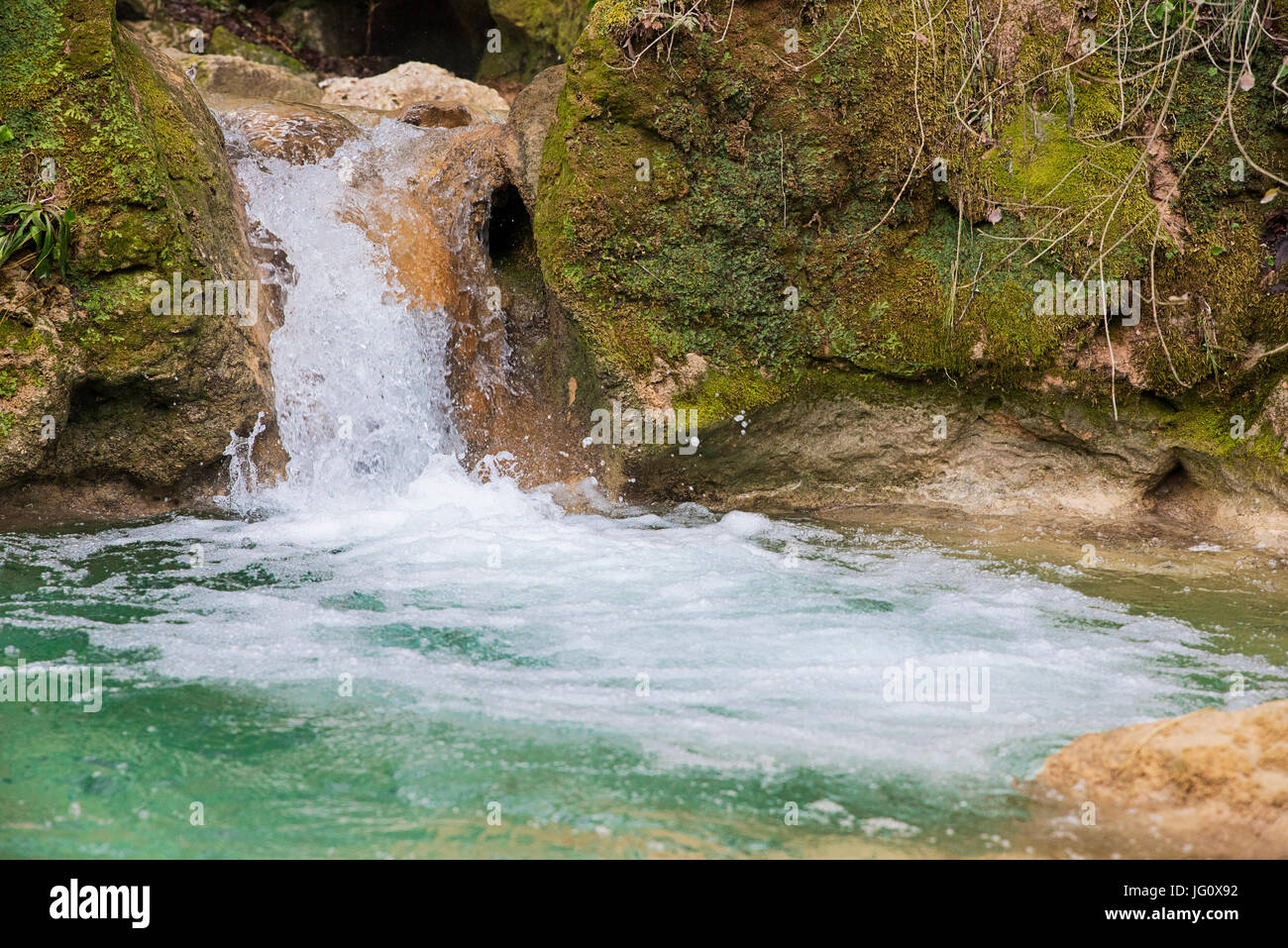 Waterfall among trees and moss covered rocks Stock Photo - Alamy