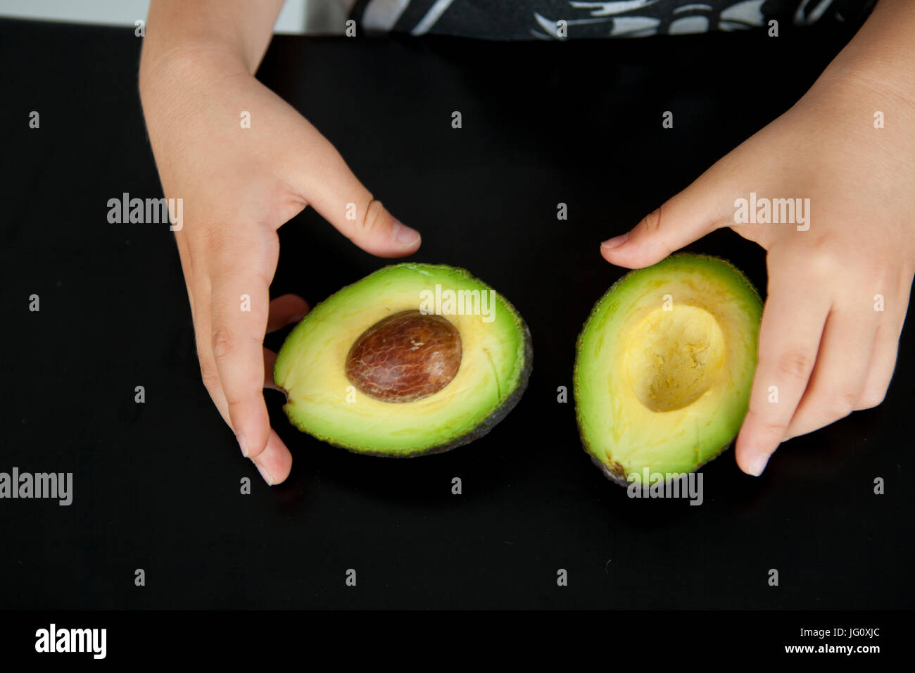 Avocado cut in half Stock Photo - Alamy
