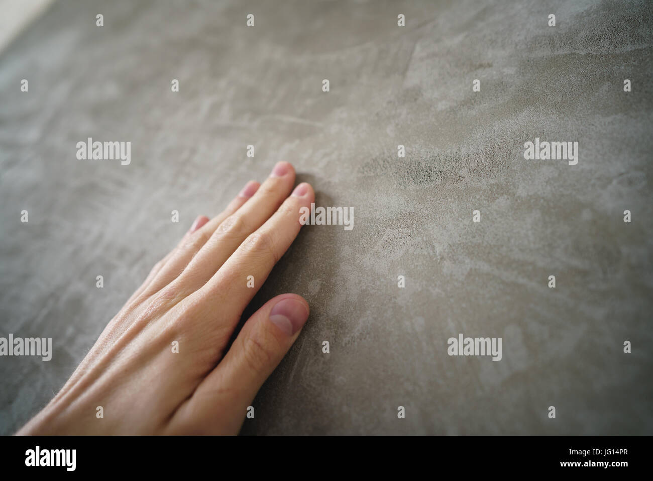 young man hand touching concrete wall, closeup photo Stock Photo - Alamy