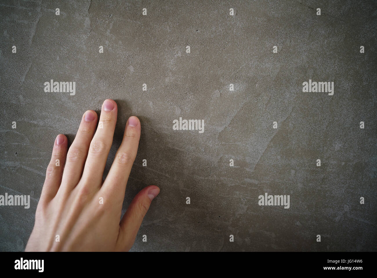 young man hand touching concrete wall, closeup photo Stock Photo - Alamy