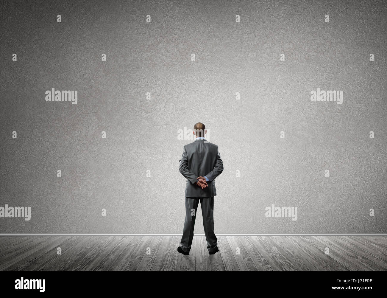 Back view of confident elegant businessman in empty concrete room Stock ...