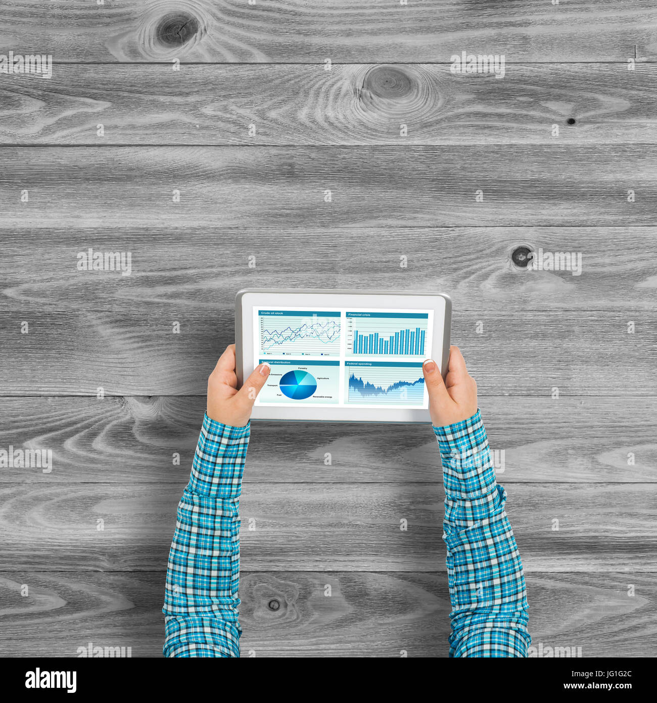 Top view of girl hands using tablet pc with diagrams and graphs on ...