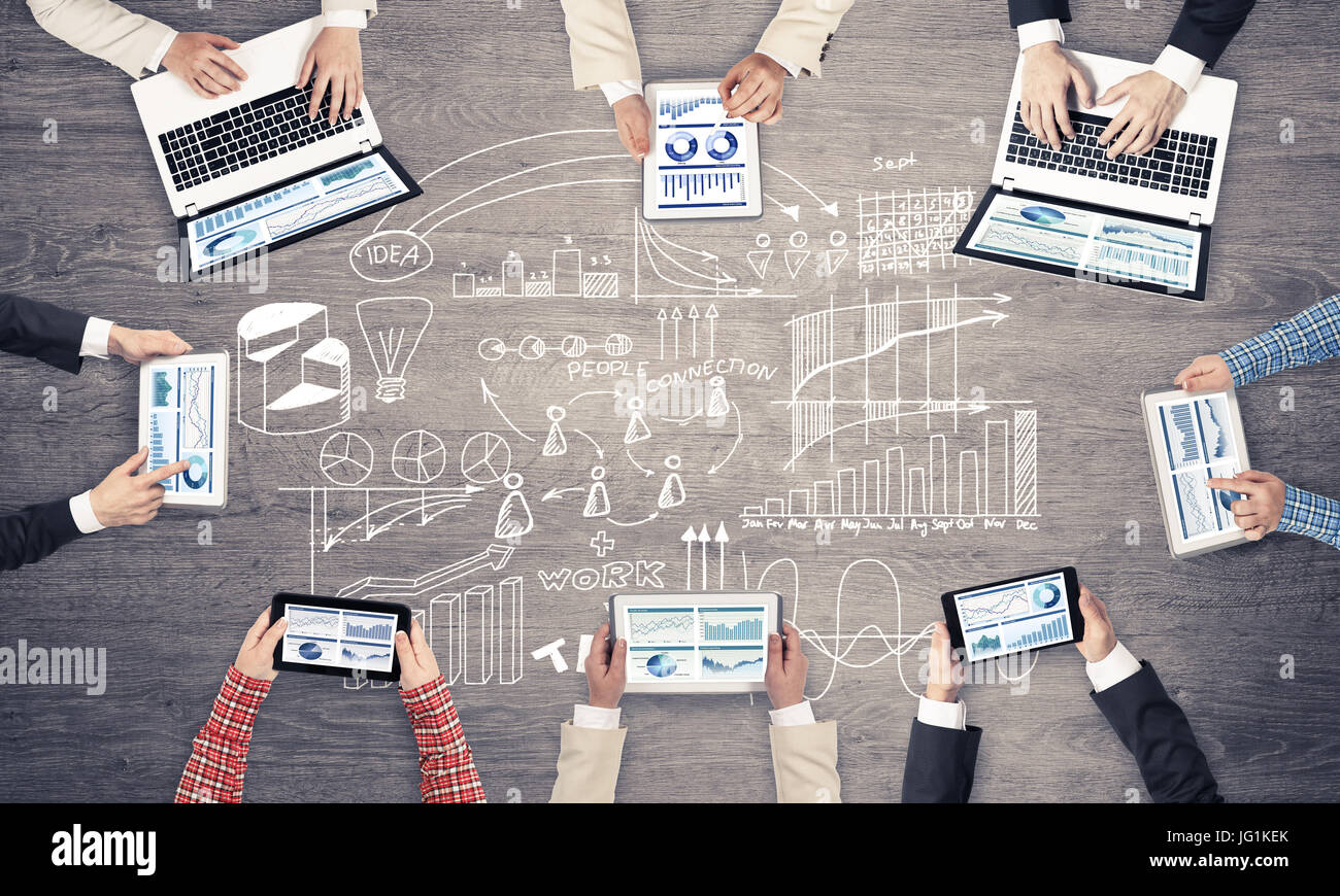 Group of people with devices in hands working together as symbol of ...