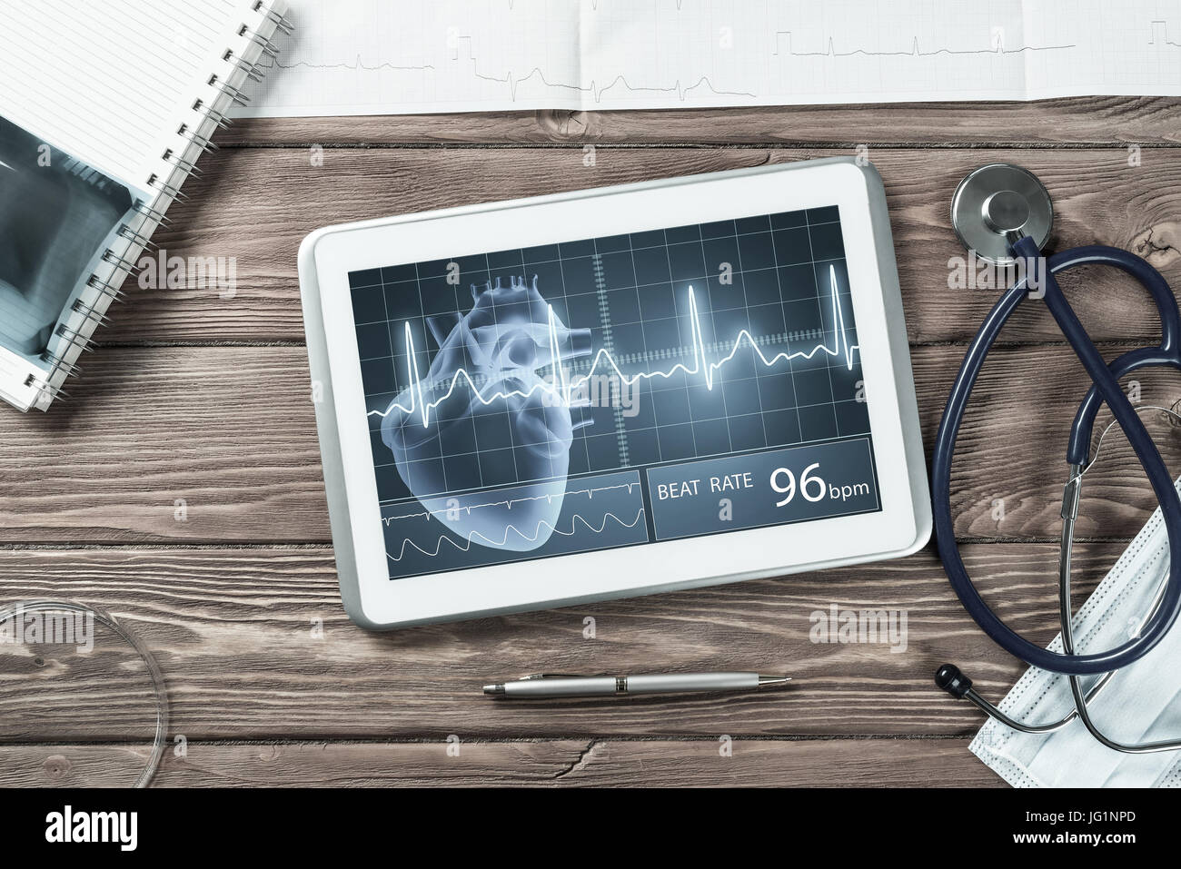 White tablet pc and doctor tools on wooden table Stock Photo - Alamy