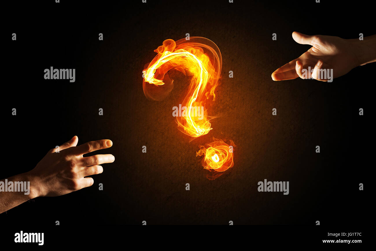 Close of businessman hand showing burning fire sign on dark background ...