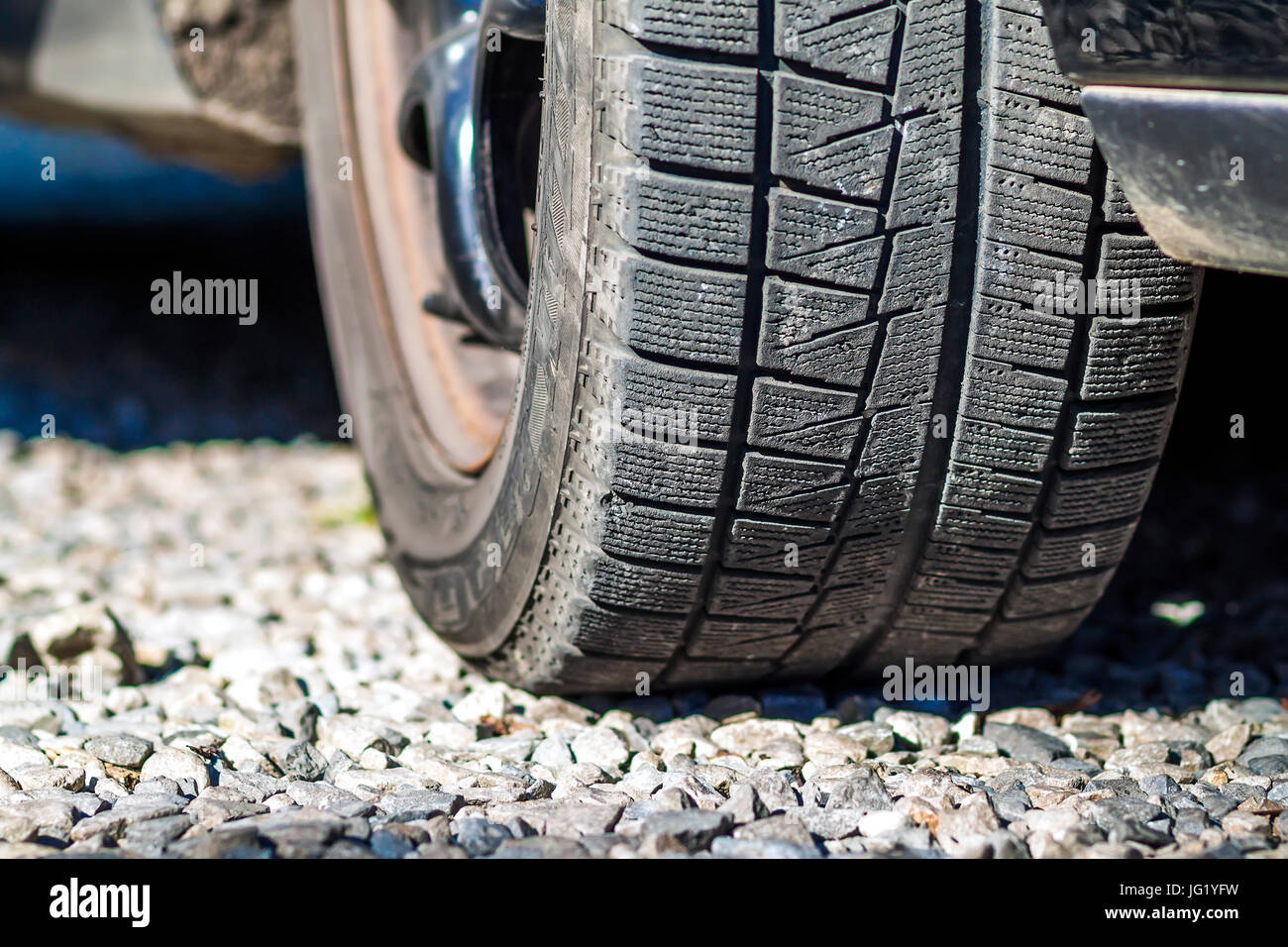 Close up of car's winter tyre tread on the gravel road Stock Photo - Alamy