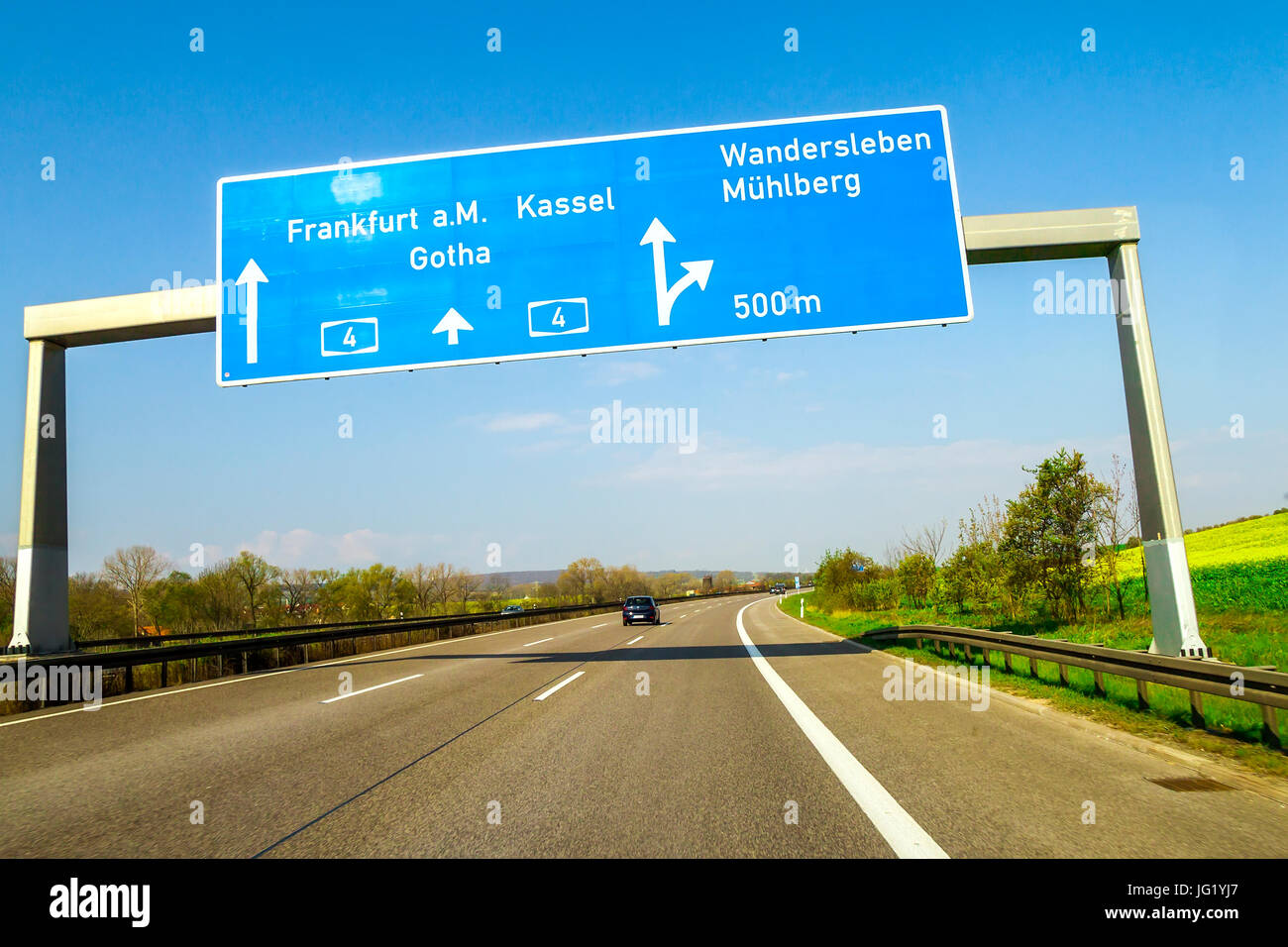 Blue freeway sign over the road in Germany on sunny day Stock Photo - Alamy
