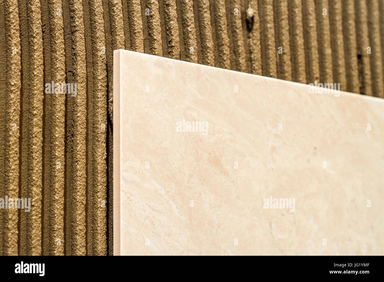 Ceramic tiles on a wall installation. Home improvement and renovation ...
