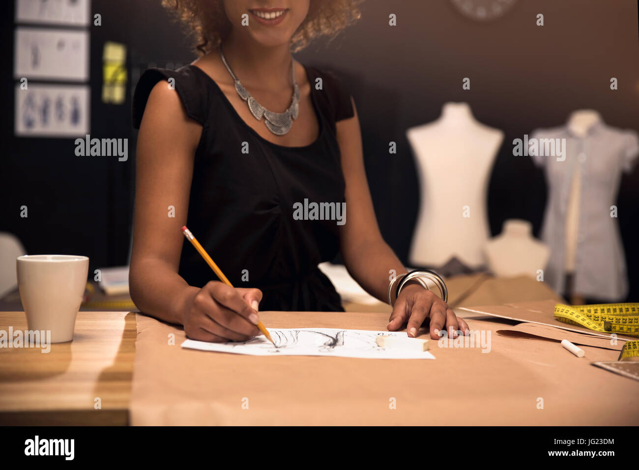 Portrait of a young fashion designer working on her atelier Stock Photo ...