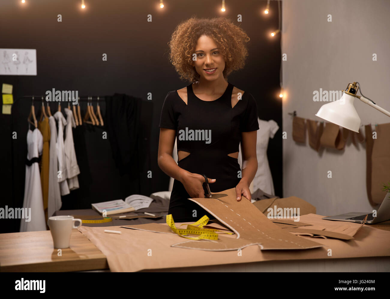 A young fashion designer working on her atelier Stock Photo - Alamy