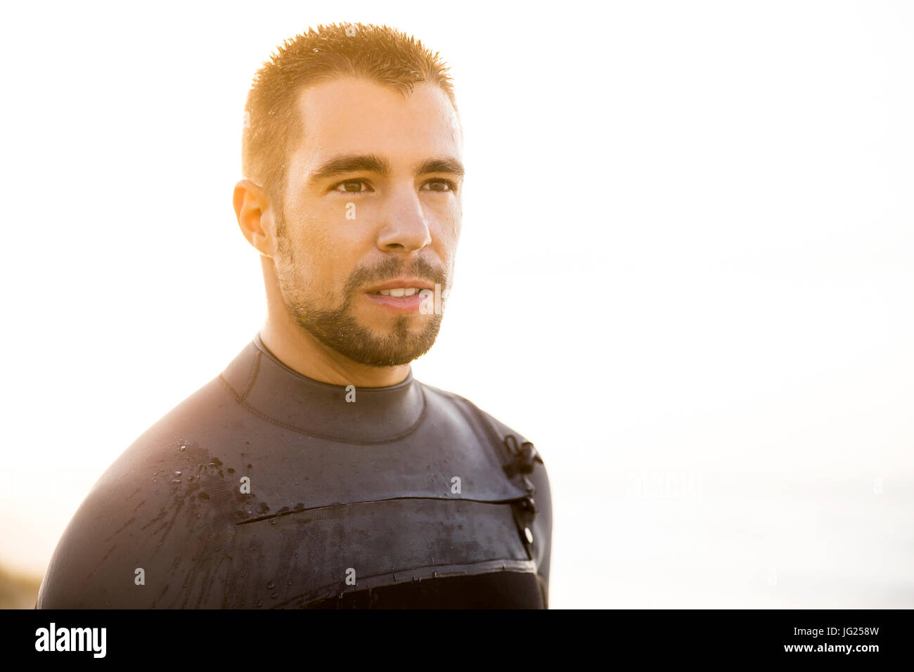 Outdoor portrait of an handsome young surfist smiling Stock Photo - Alamy