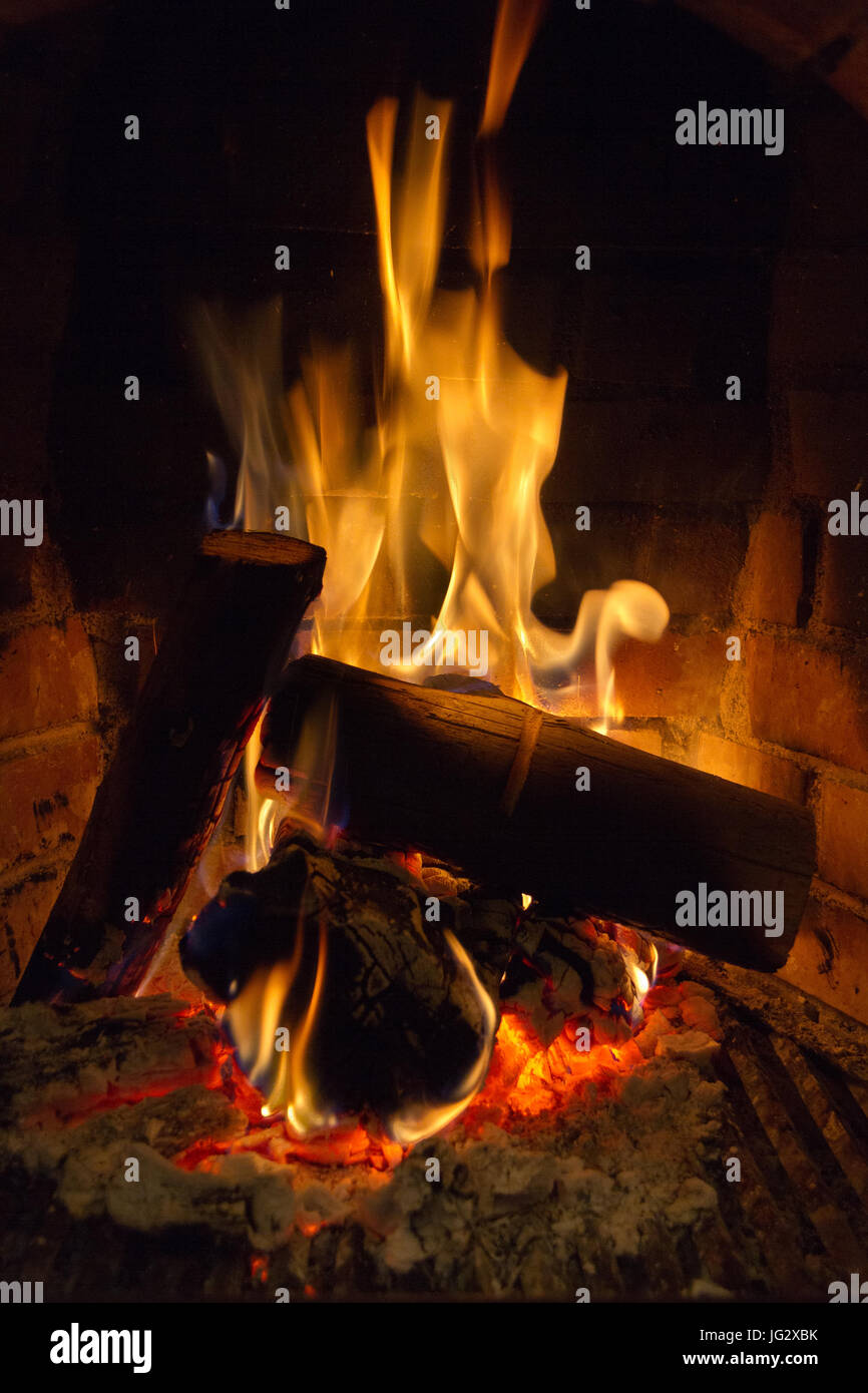 Burning logs in a fireplace photographed in a holiday villa in ...