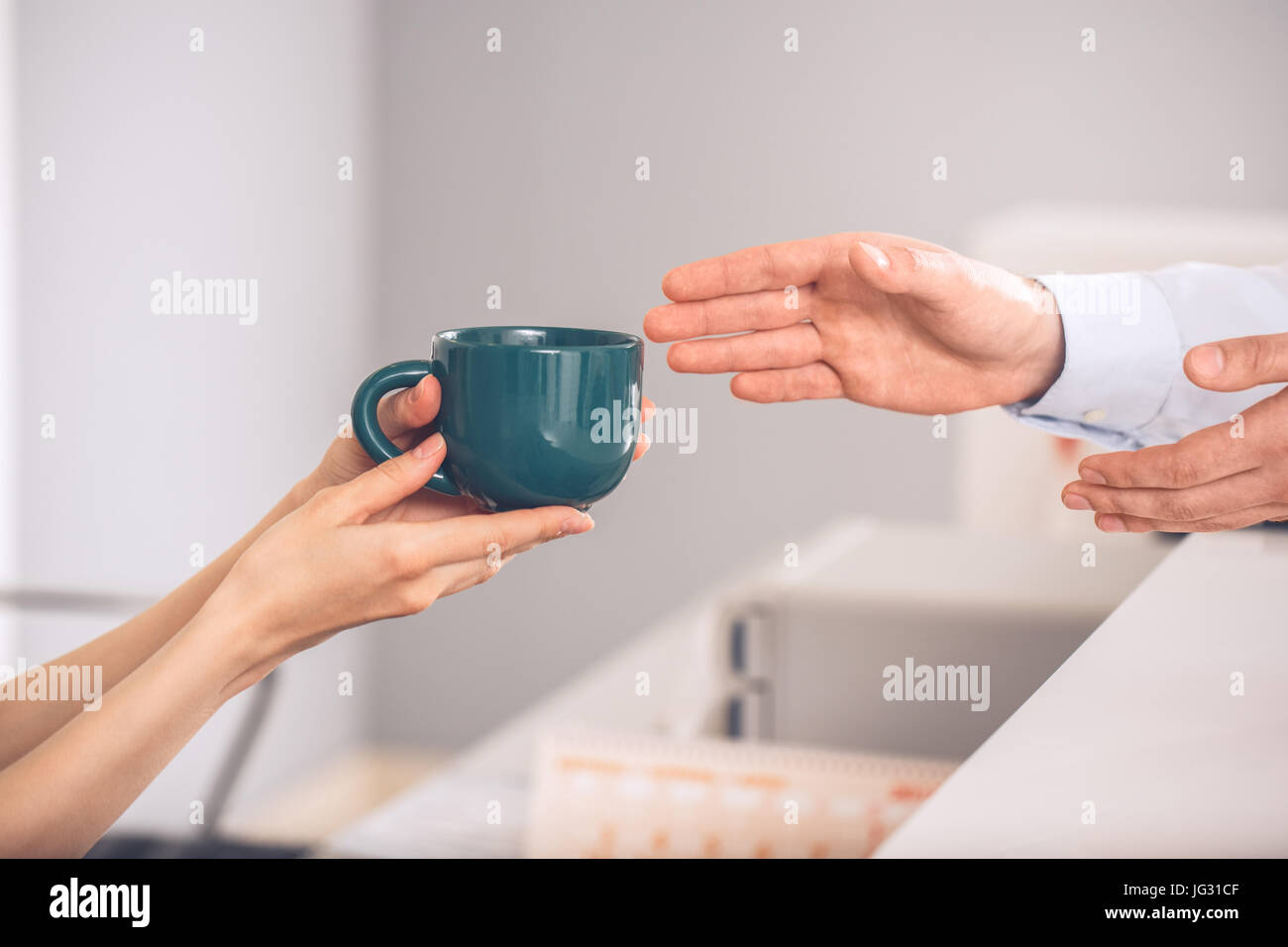 Woman giving tea office hi-res stock photography and images - Alamy