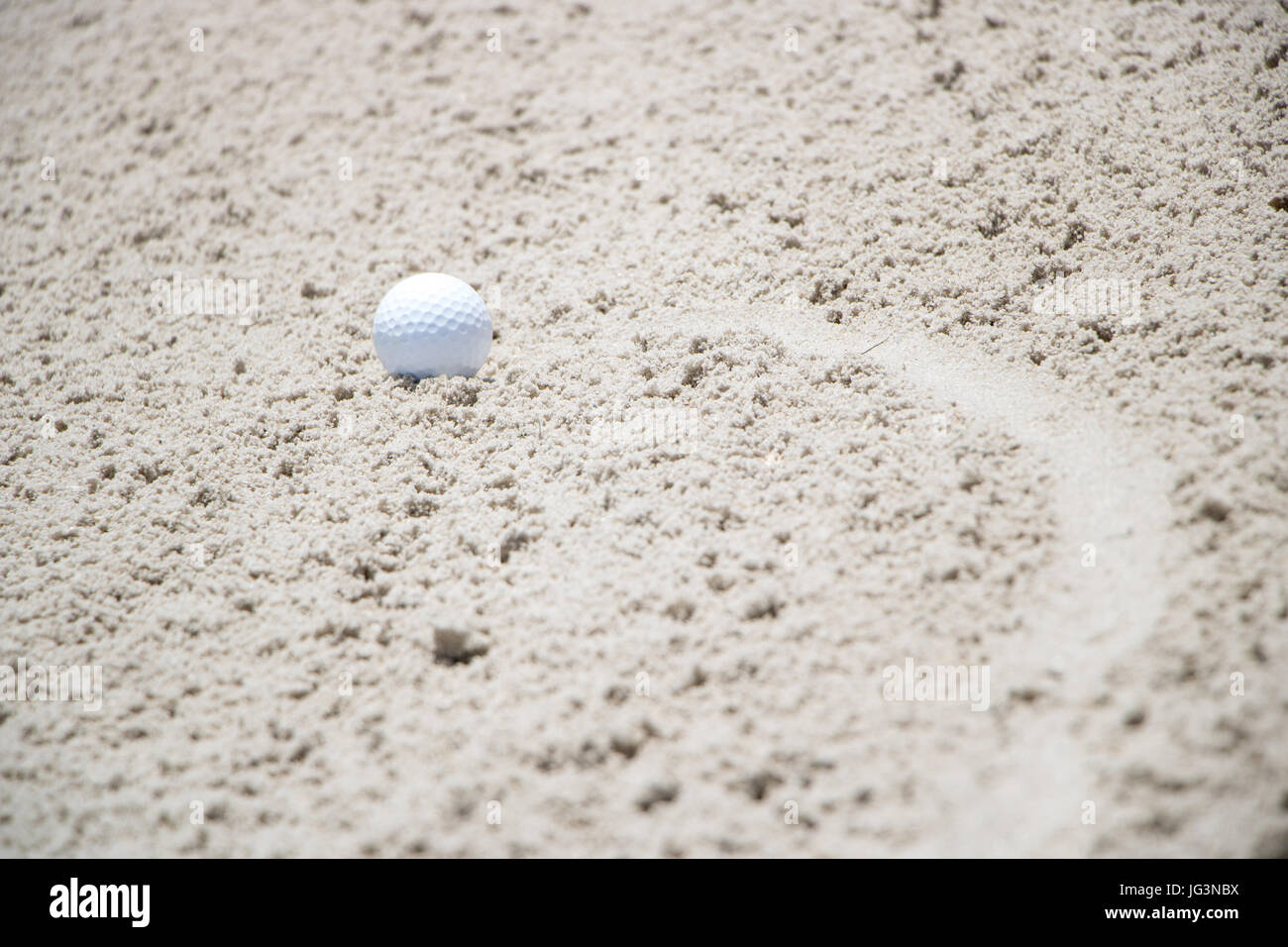 Golf Ball in Sand Trap Stock Photo - Alamy