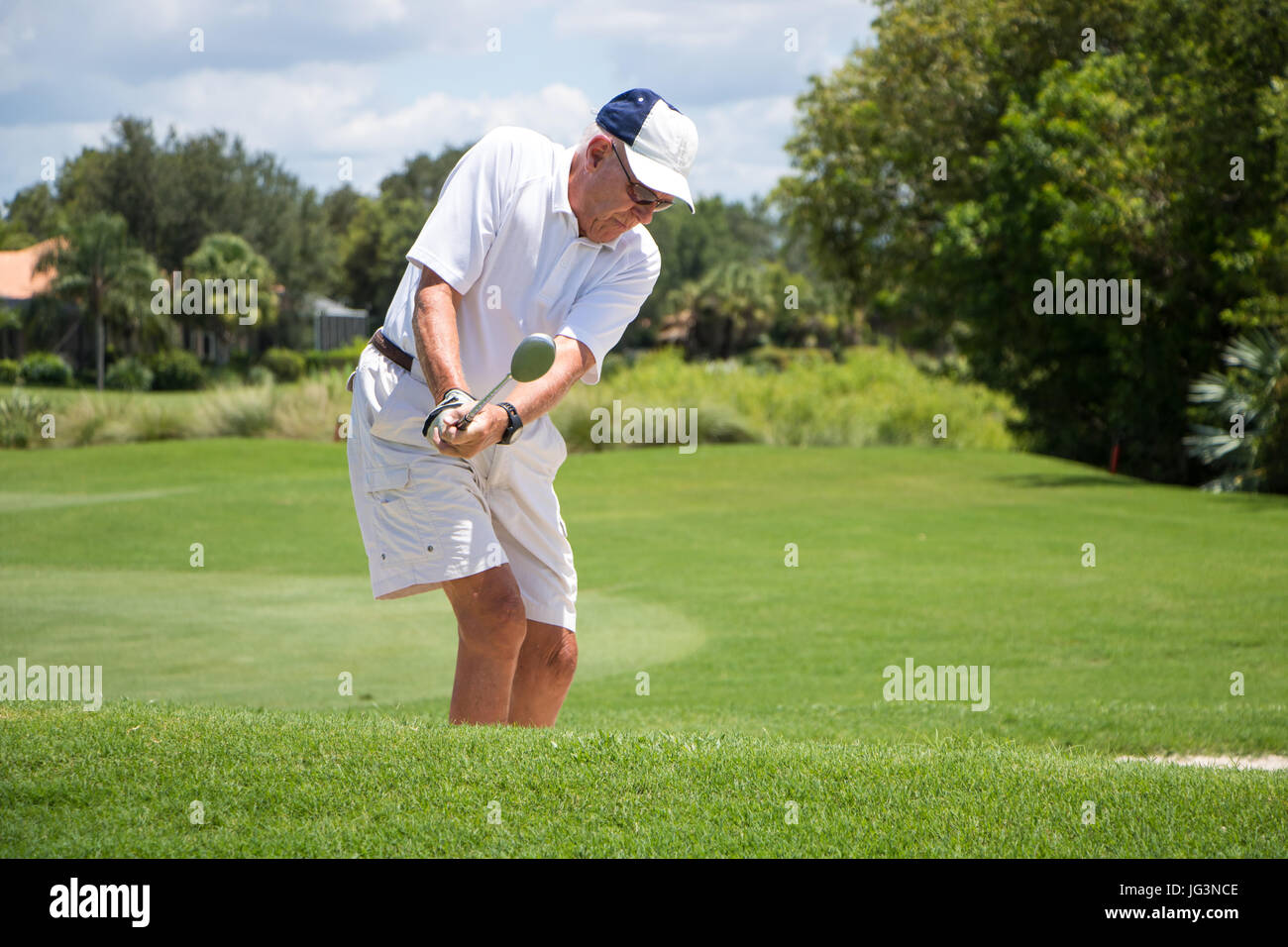 Golfer Hitting Ball Stock Photo - Alamy