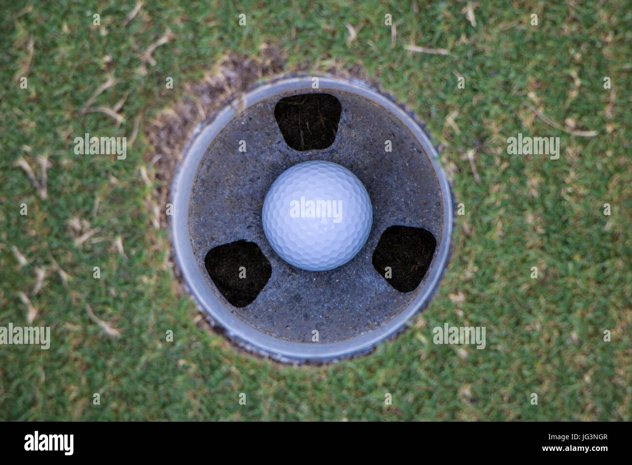 Golf Ball in Hole Stock Photo - Alamy