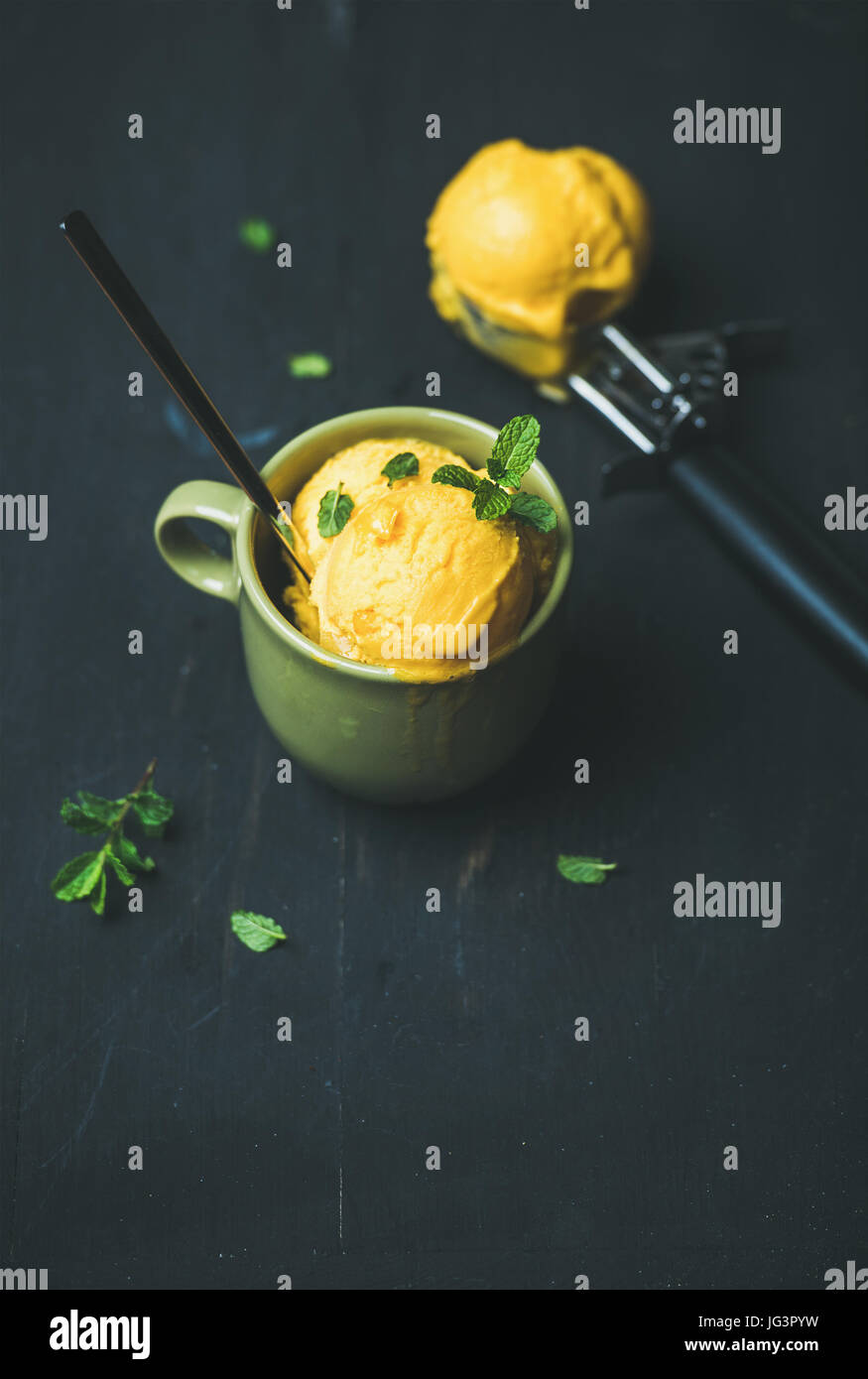 Mango sorbet ice cream scoops with fresh mint in cup Stock Photo - Alamy